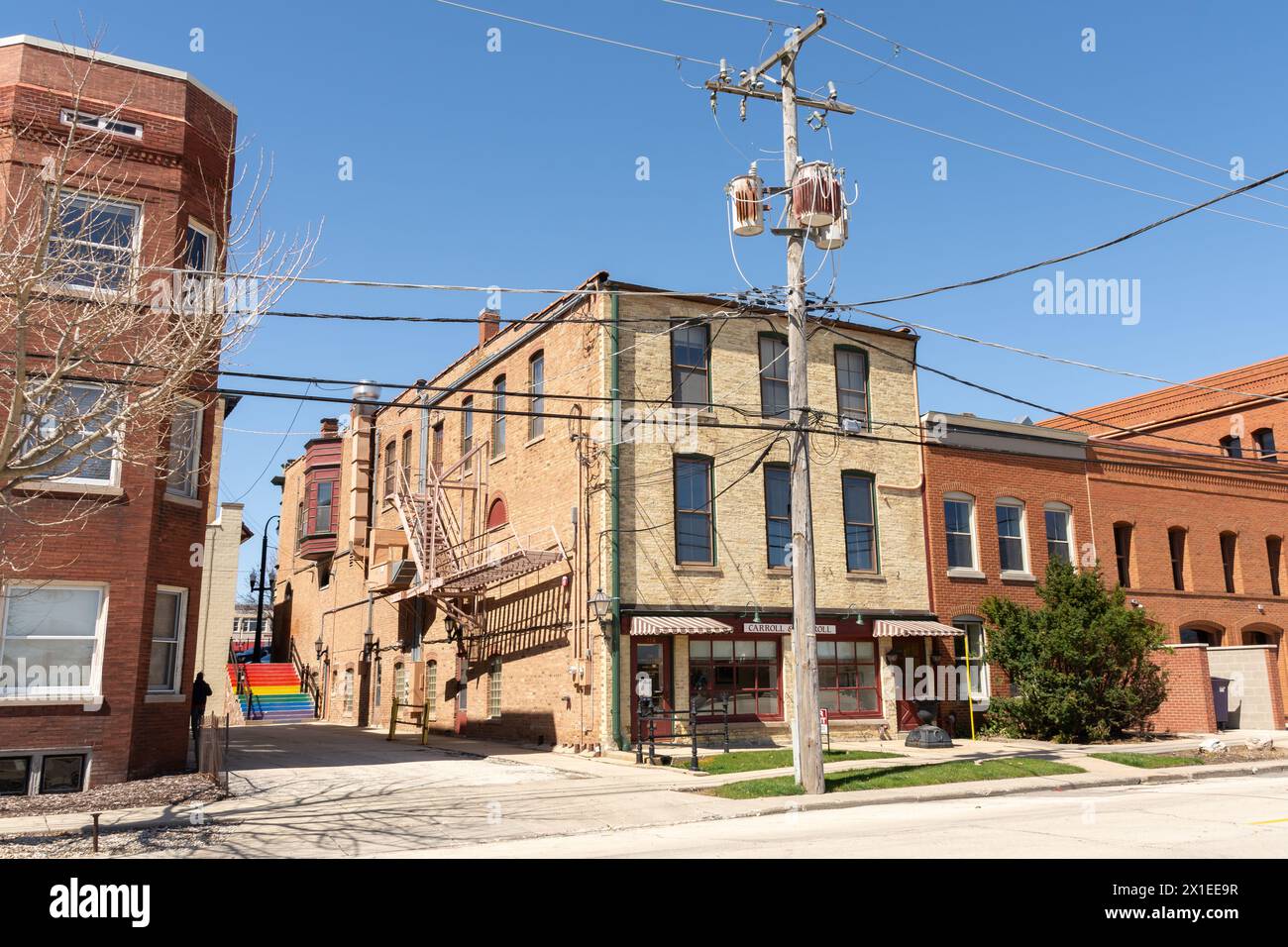 Old storefront and alleyway with staircase painted in rainbow colors ...