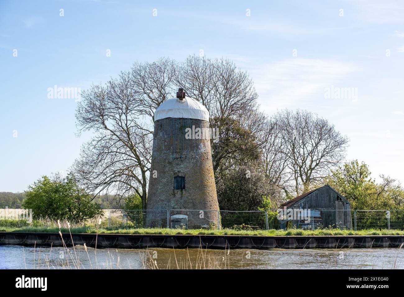 Old, disused and abandoned drainage mill on the bank of the Bure River ...