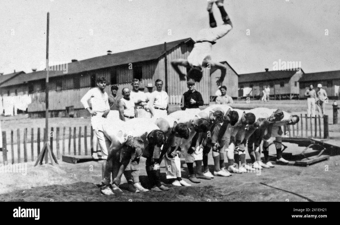 WAR PRISON BARRACKS NO. 1, FT. MCPHERSON, GA. Gymnastics. A jump over 10 men ca. 1918-1919 Stock ...