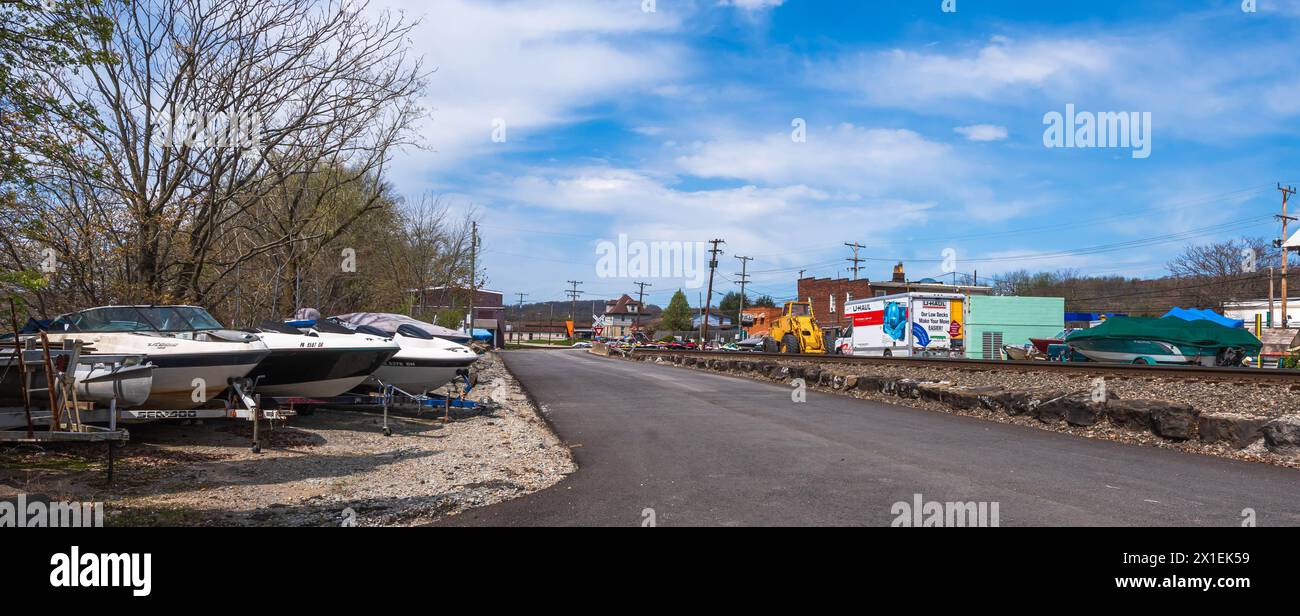 Boats parked on the side of the road at Cheswick Marina with buildings ...
