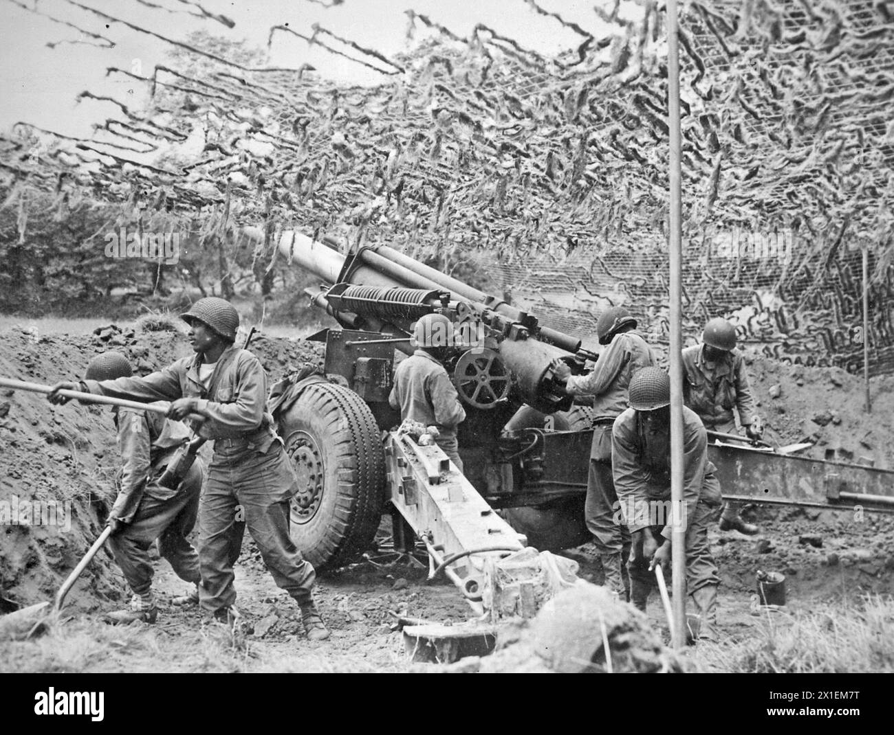 Troops of a field artillery battery emplace a 155mm howitzer in France ...