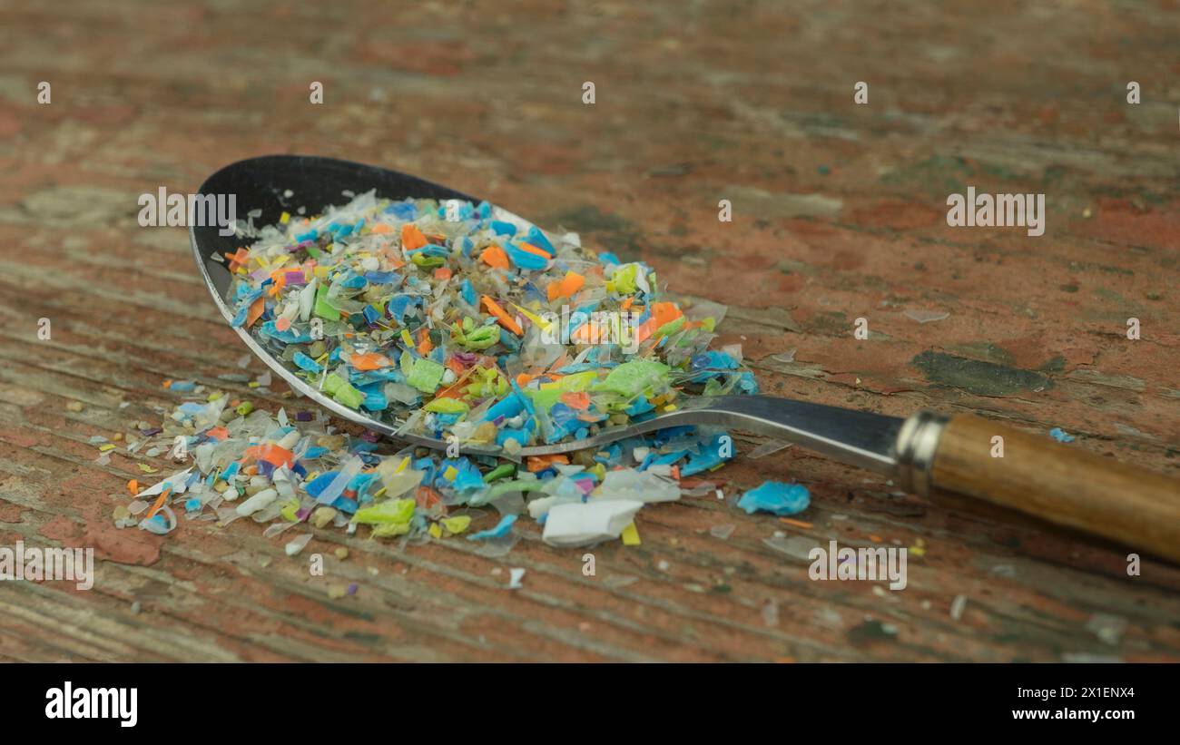 Microplastics in a spoon. A concept of consuming microplastic particles ...