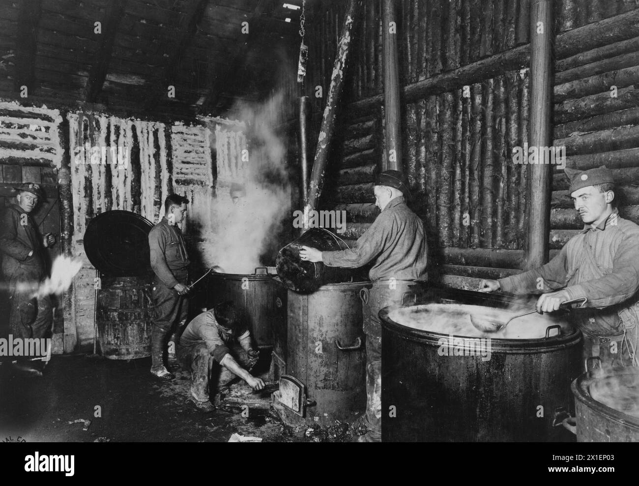 Soldiers working in a fully equipped kitchen with eight boilers ready ...