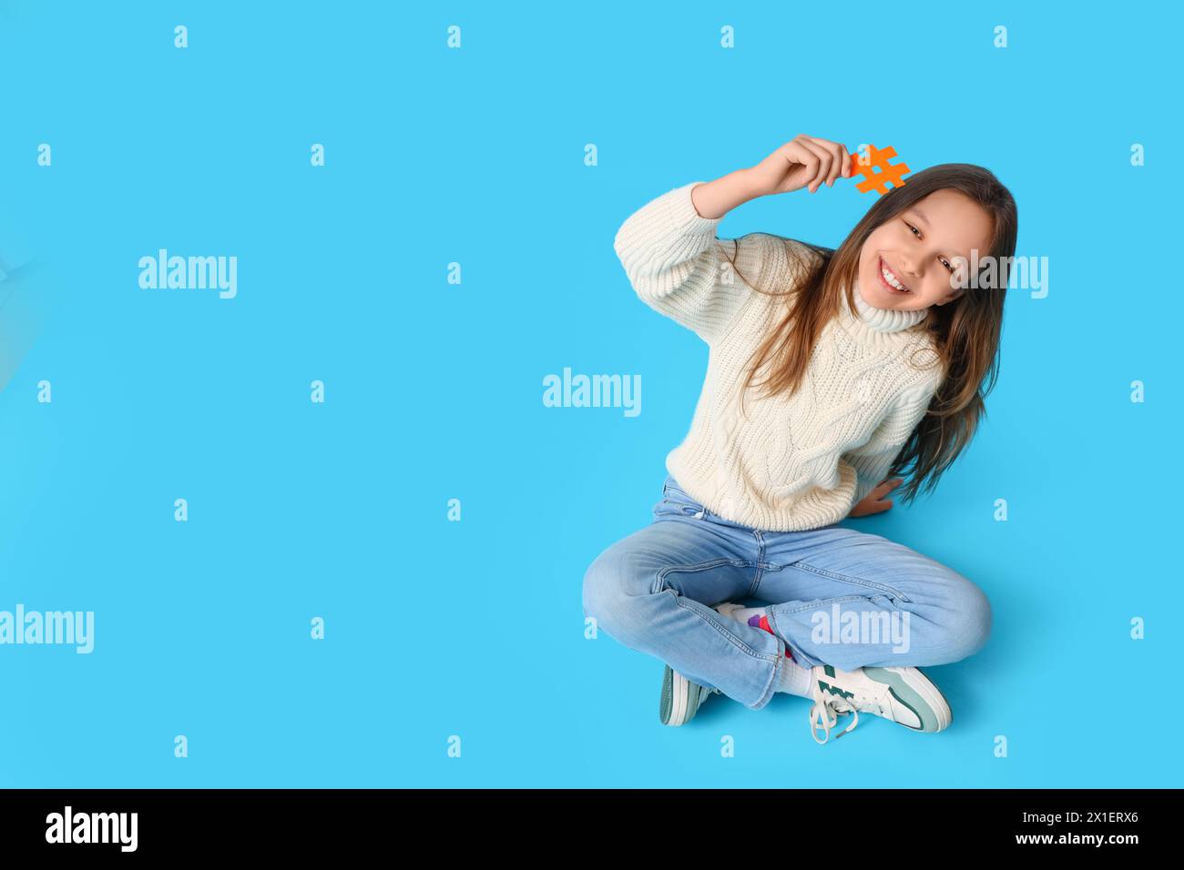 Cute teenage girl with hashtag on blue background Stock Photo - Alamy