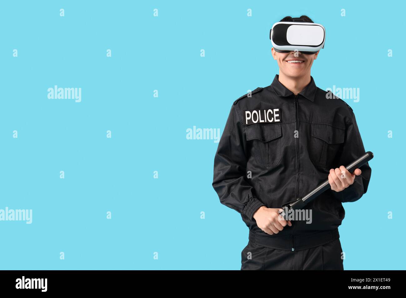 Male police officer in VR glasses with baton on blue background Stock ...