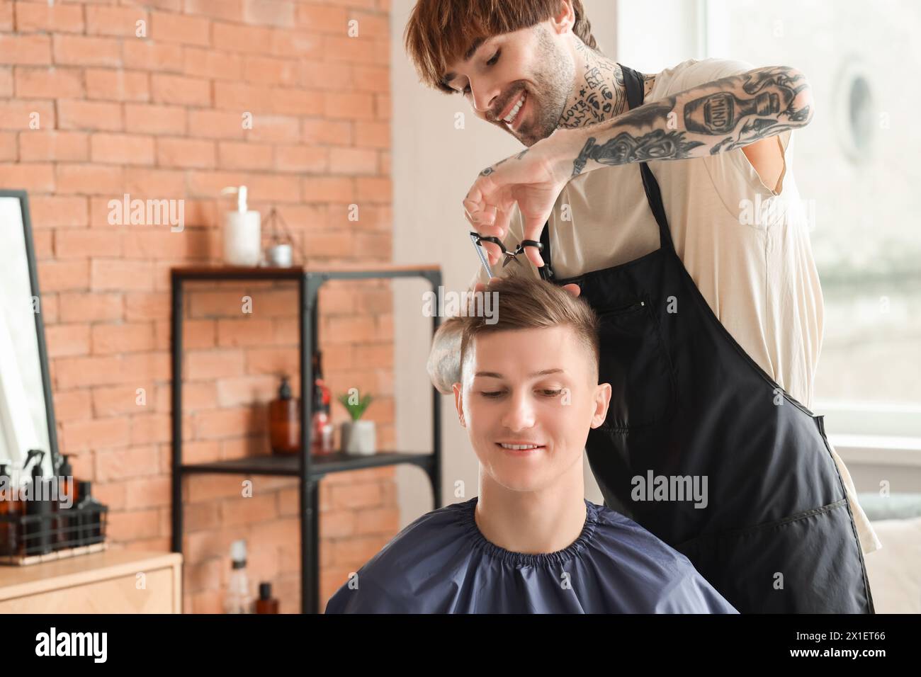 Barber giving client haircut hi-res stock photography and images - Alamy