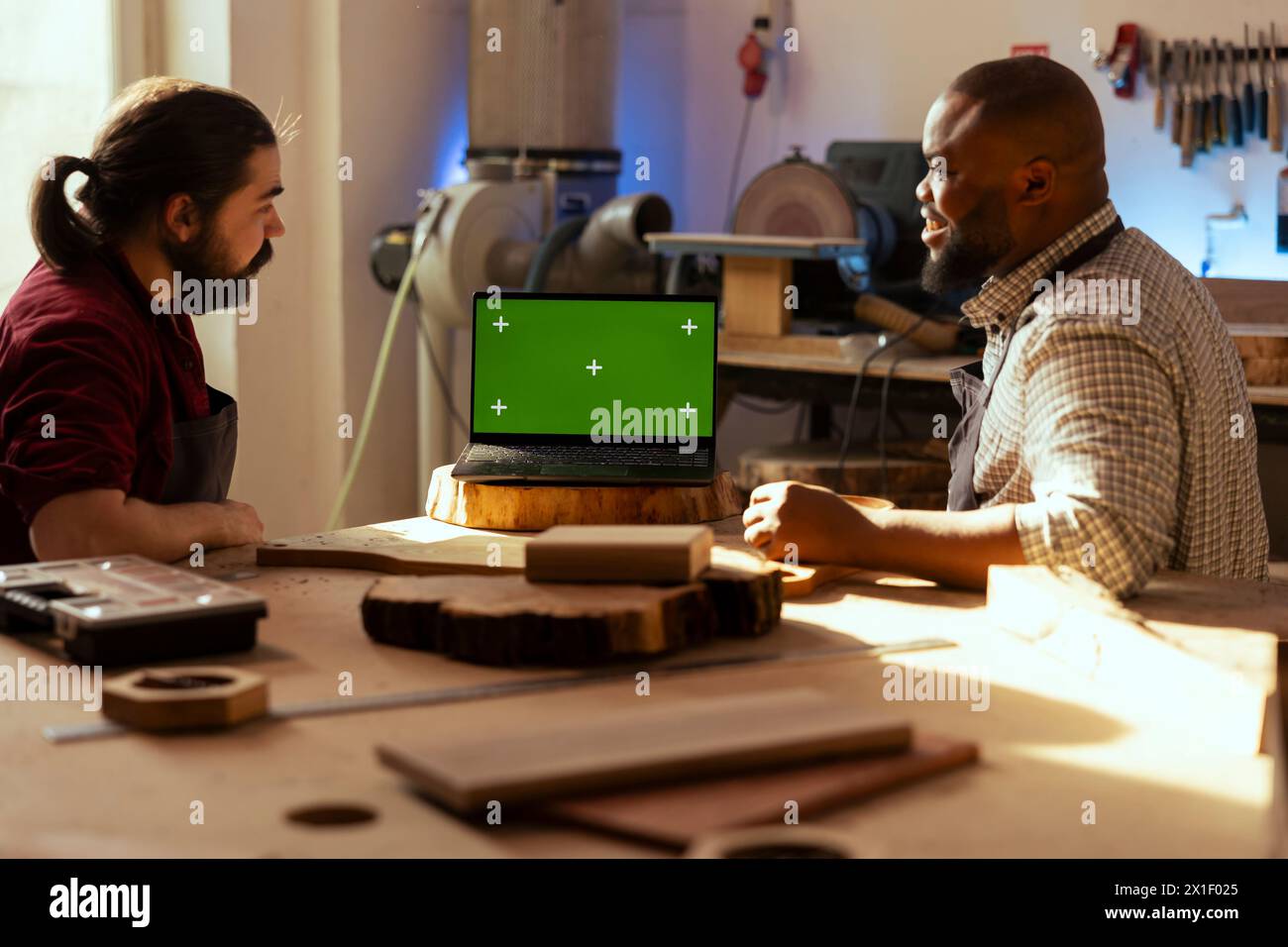 Happy manufacturers using CAD software on isolated screen laptop ...