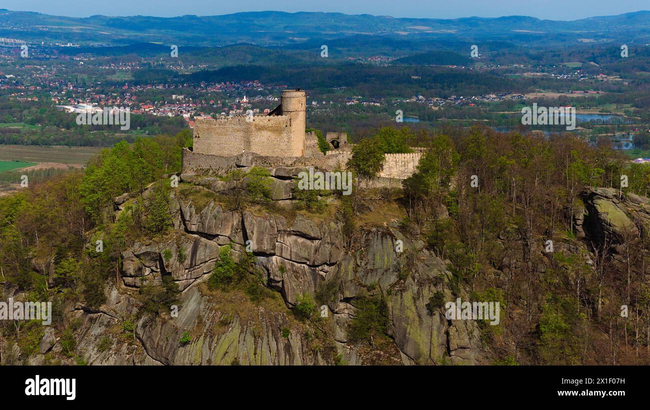 An aerial view captures the medieval Chojnik Castle atop a mountain in ...