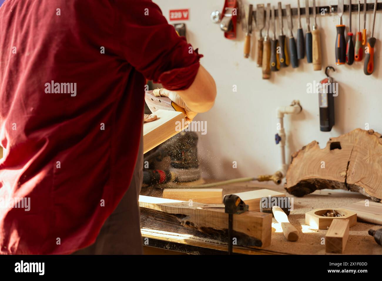 Manufacturer using sandpaper for smoothing wooden surface before ...