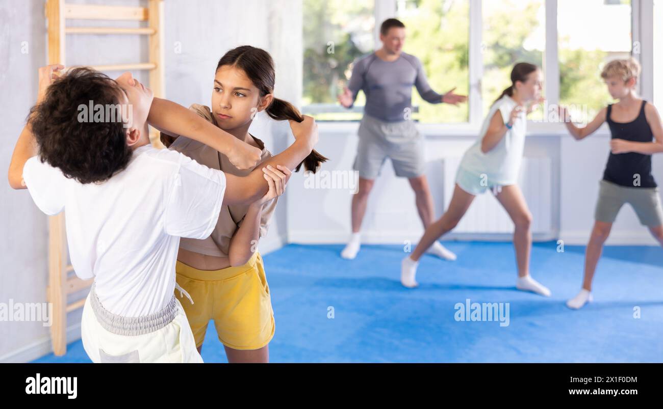 Boy and girl practicing self-defense techniques Stock Photo - Alamy