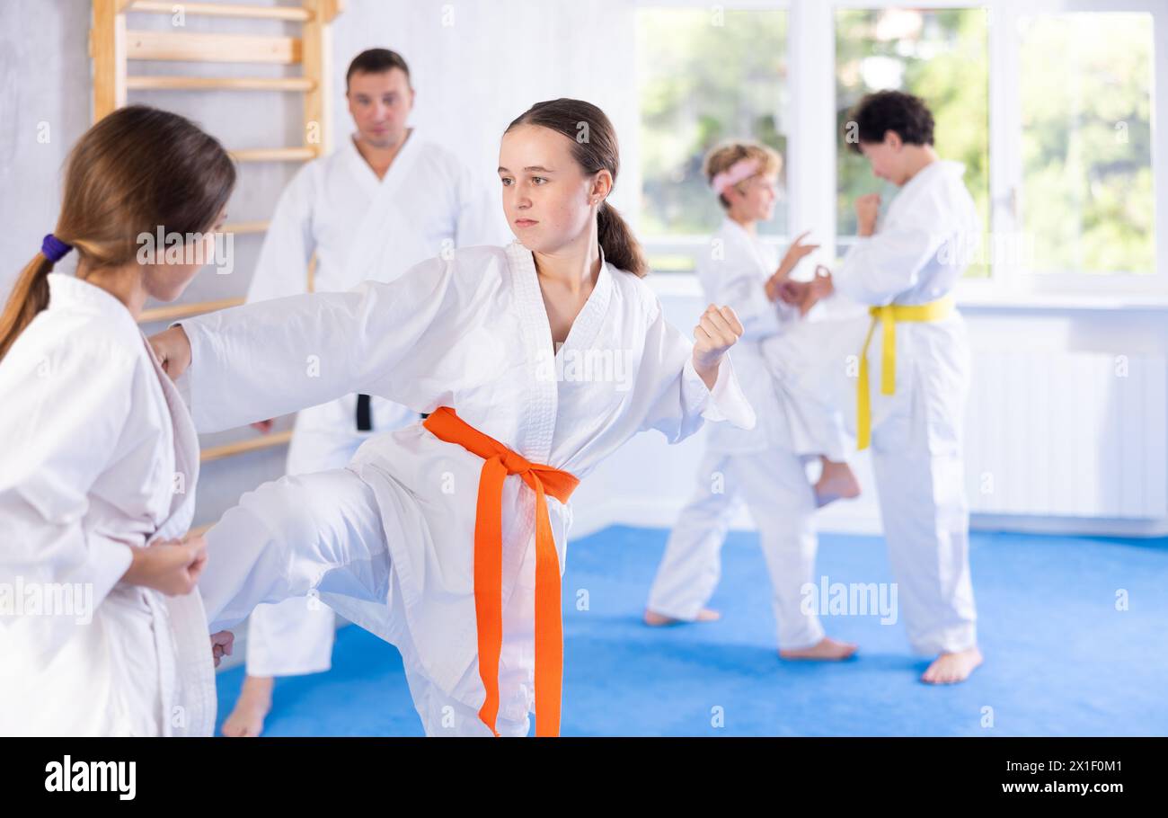 Two girls training karate techniques in studio Stock Photo - Alamy
