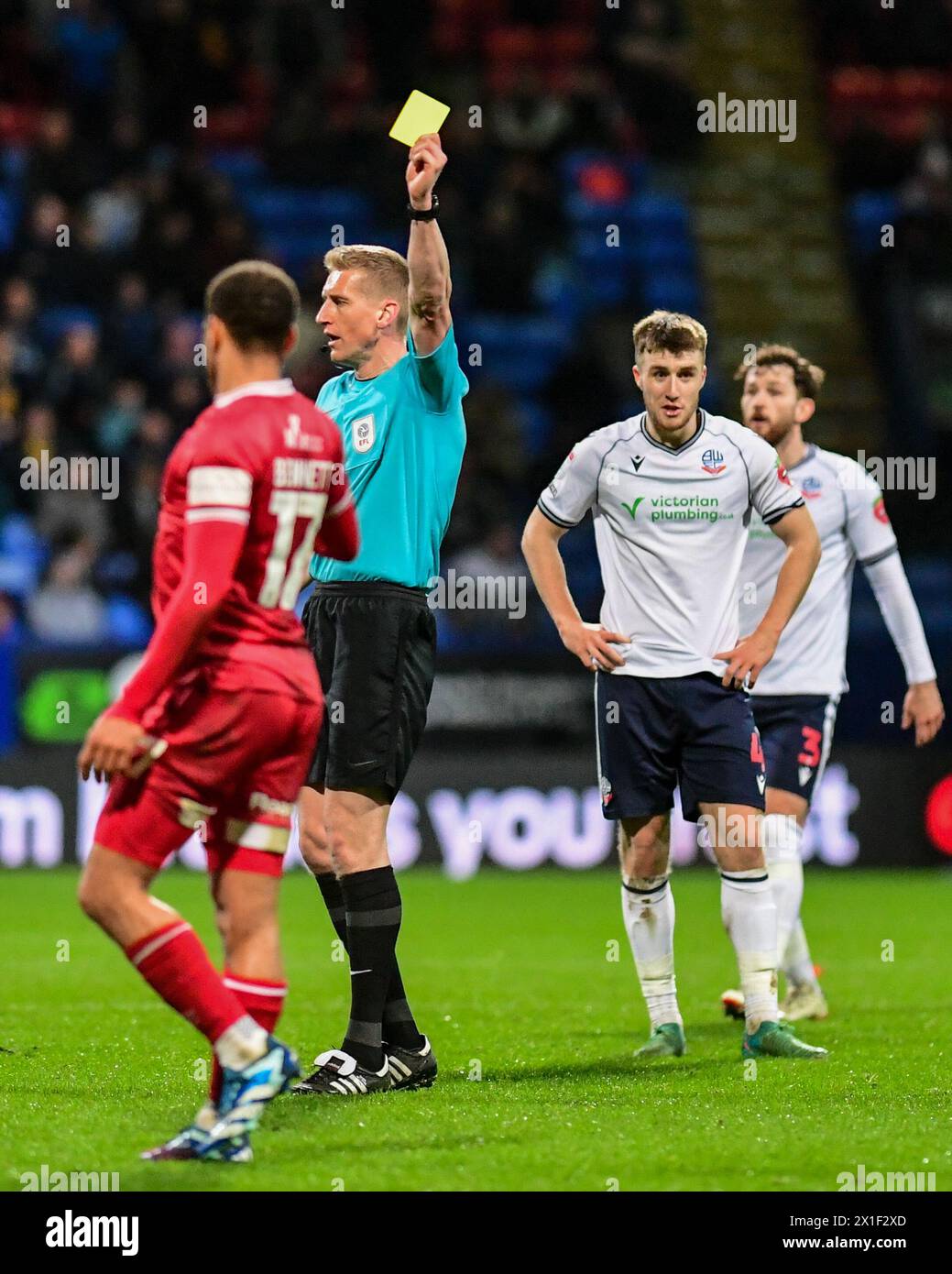 Bolton, UK. 16th Apr, 2024. Referee Scott Oldham gives a yellow card to ...