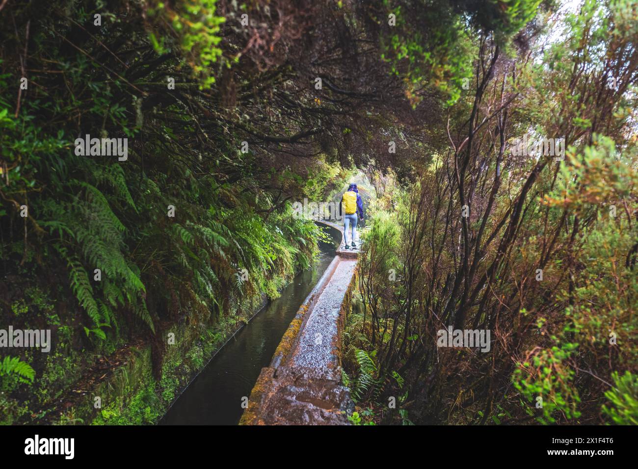 Description: Female tourist with backpack walkes on water channel ...