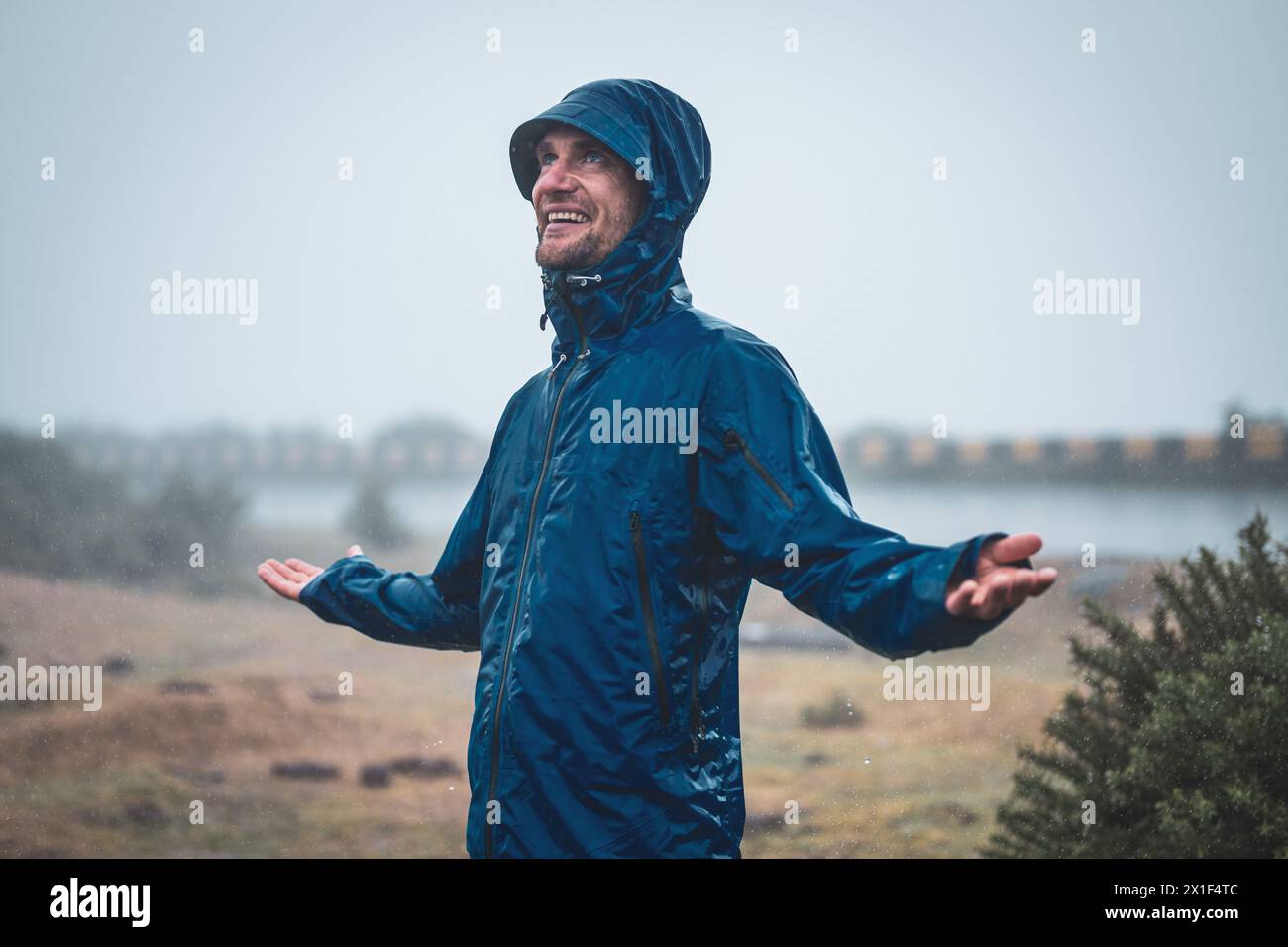 Description: Happy and healthy male traveler staring at the sky while ...