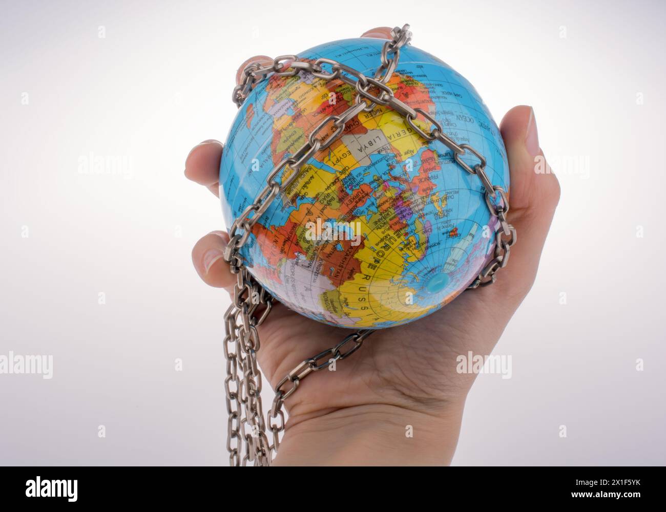 Globe in chain on a white background Stock Photo - Alamy
