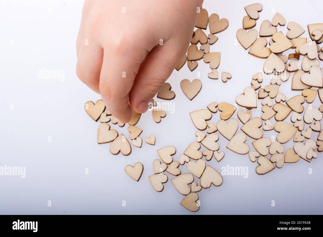 Retro style wooden hearts under hand as love concept Stock Photo - Alamy