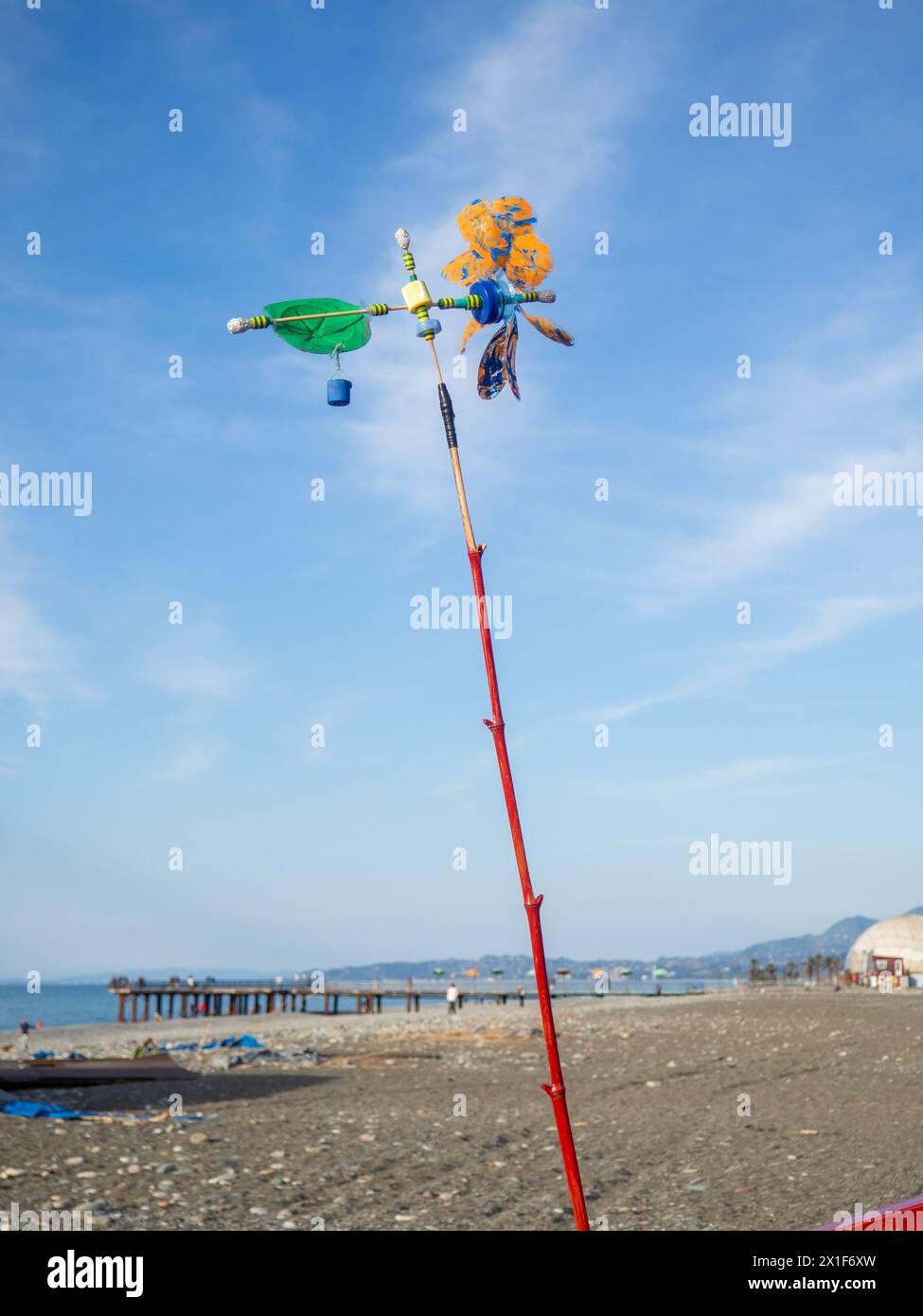 Homemade weather vane from a plastic bottle on the seashore. Wind ...