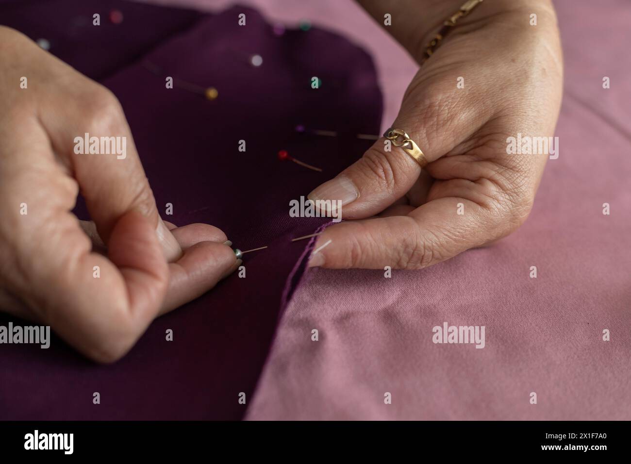 Latin American seamstress inserts sewing pins Stock Photo - Alamy