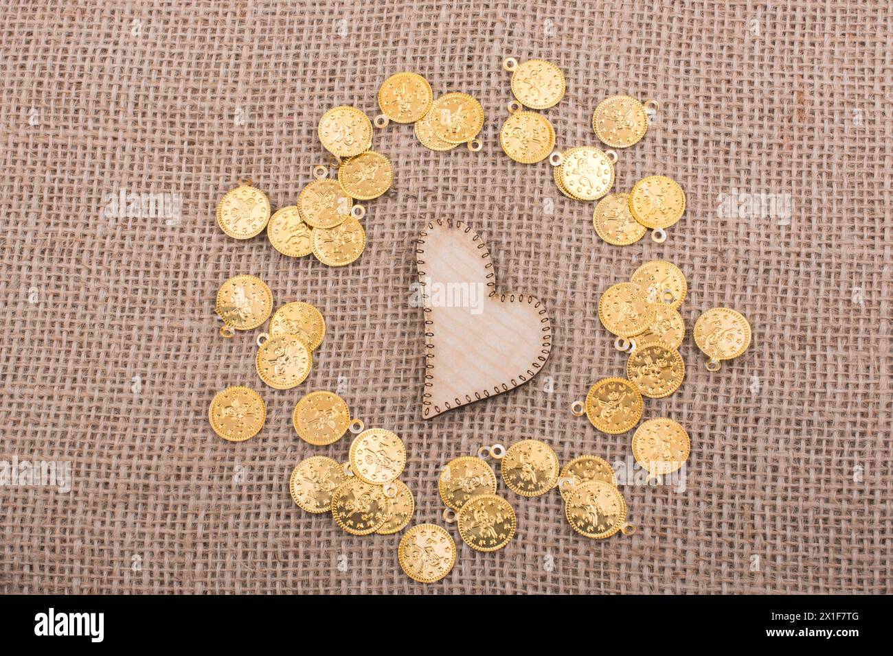 Fake gold coins around heart shape made of paper Stock Photo - Alamy