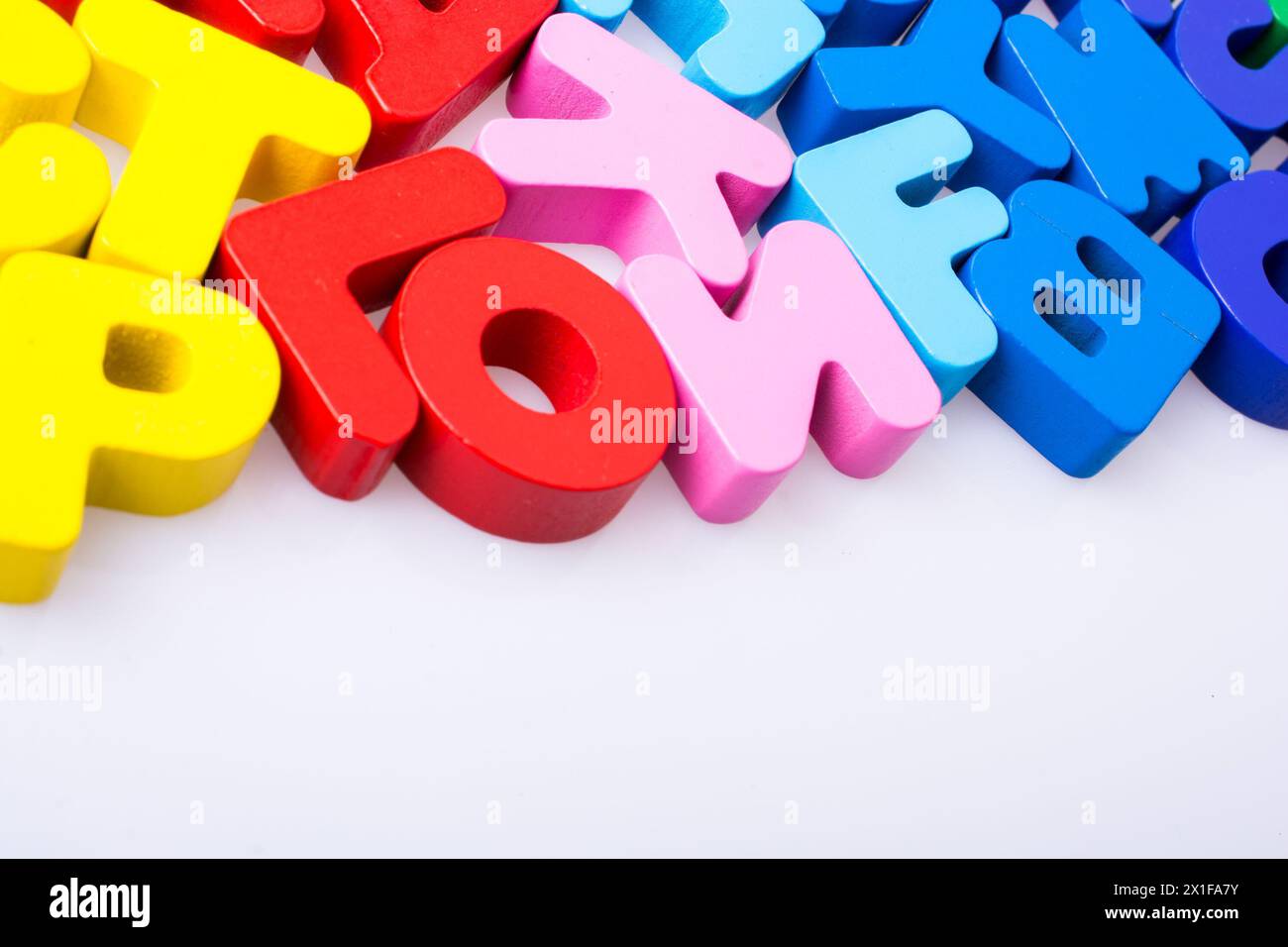 Colorful alphabet letter blocks scattered randomly on white background ...