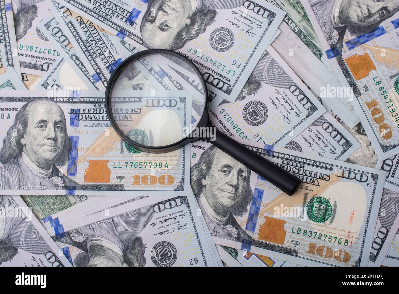 Magnifying glass is placed over of US dollar the banknotes Stock Photo ...