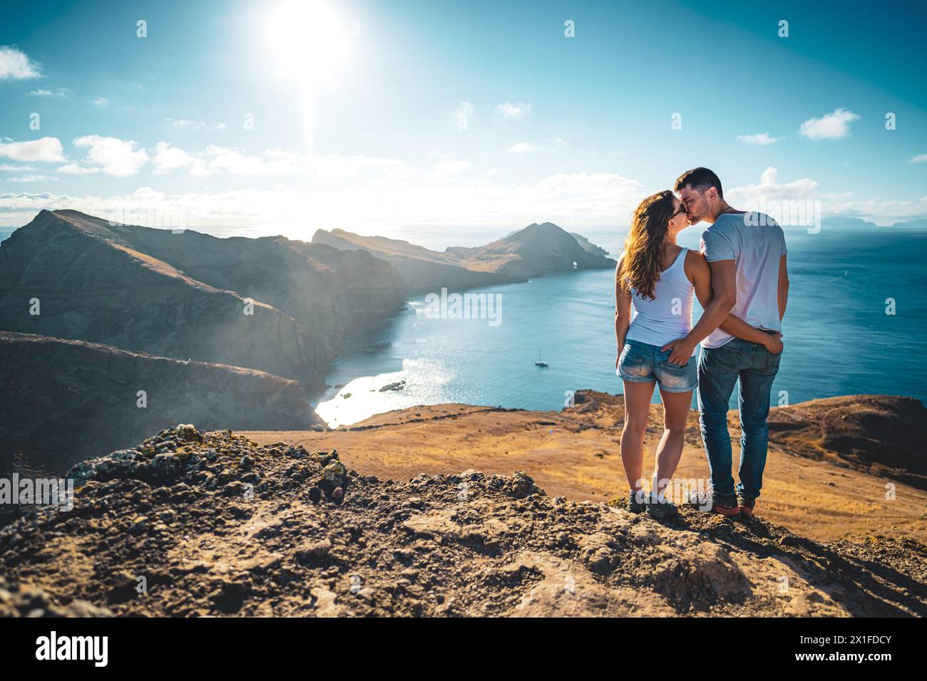 Description: Back view of sporty tourist couple kissing with coastal ...