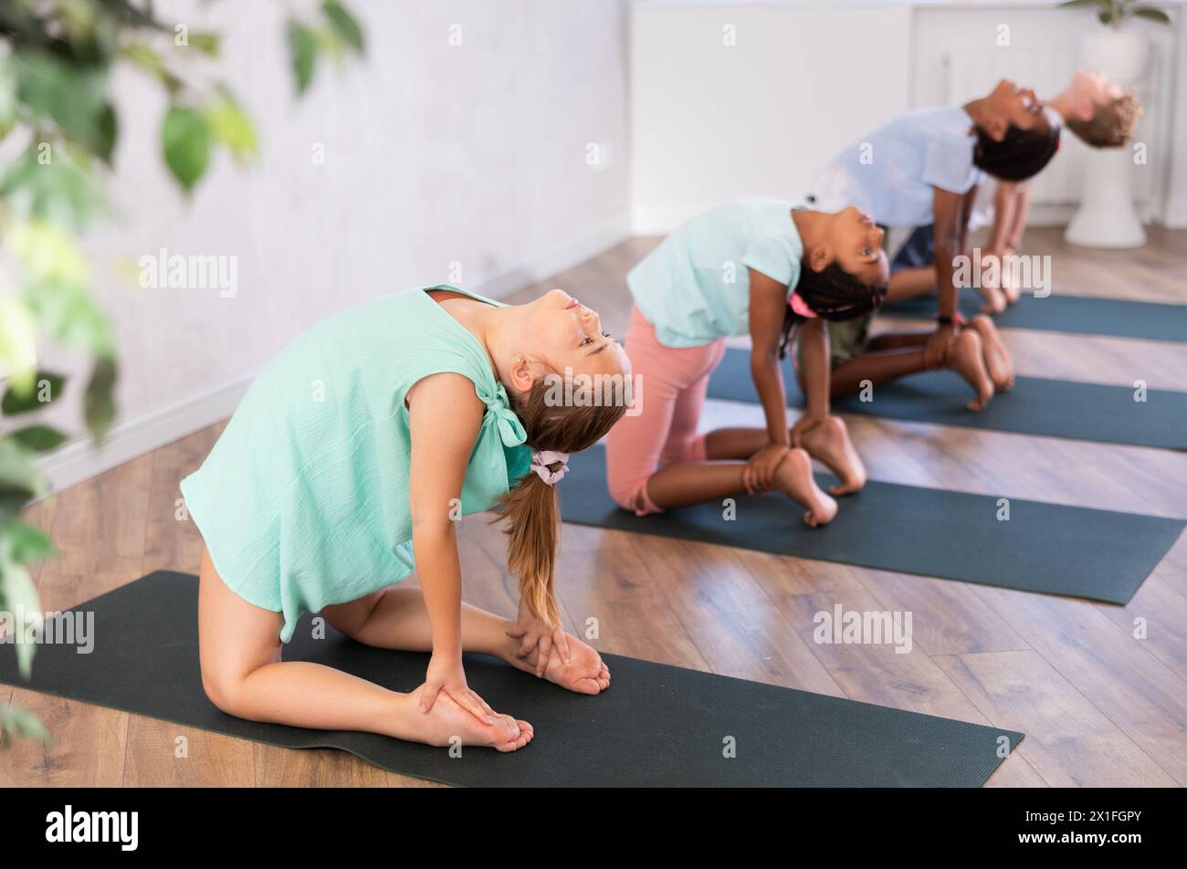 Group of preteen children practicing yoga lesson at sport club Stock ...