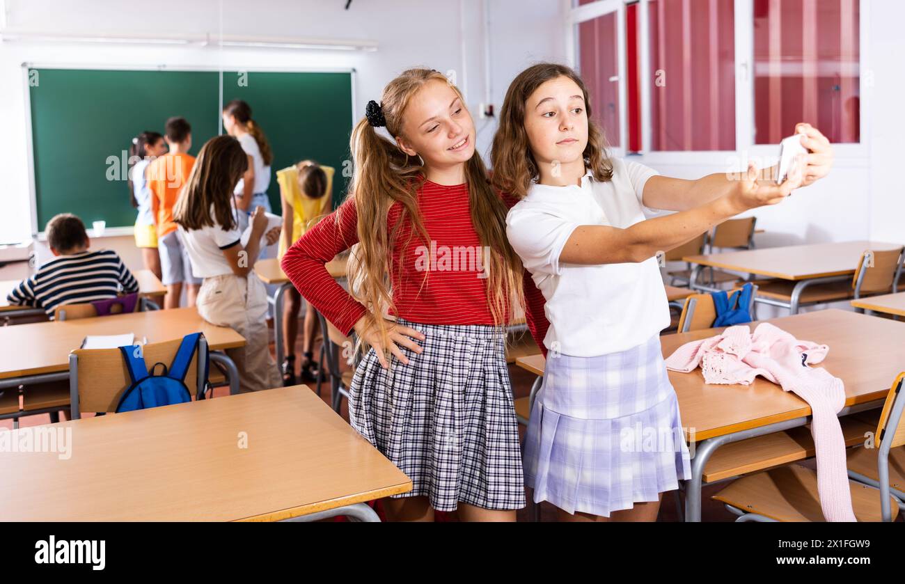 Two positive schoolgirls are photographed during a break in school ...