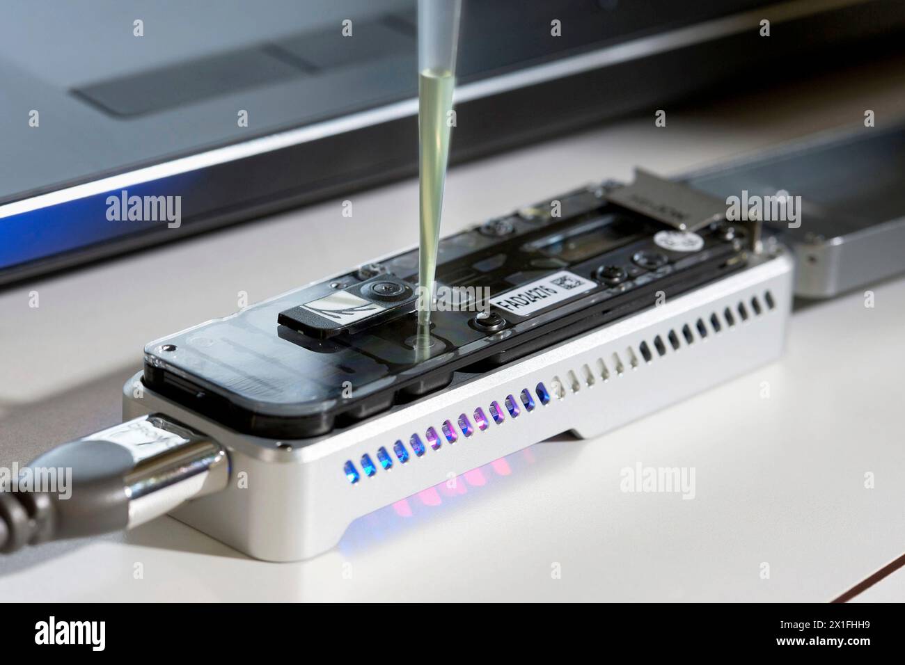 DNA (deoxyribonucleic acid) sample being loaded into a sequencing flow ...