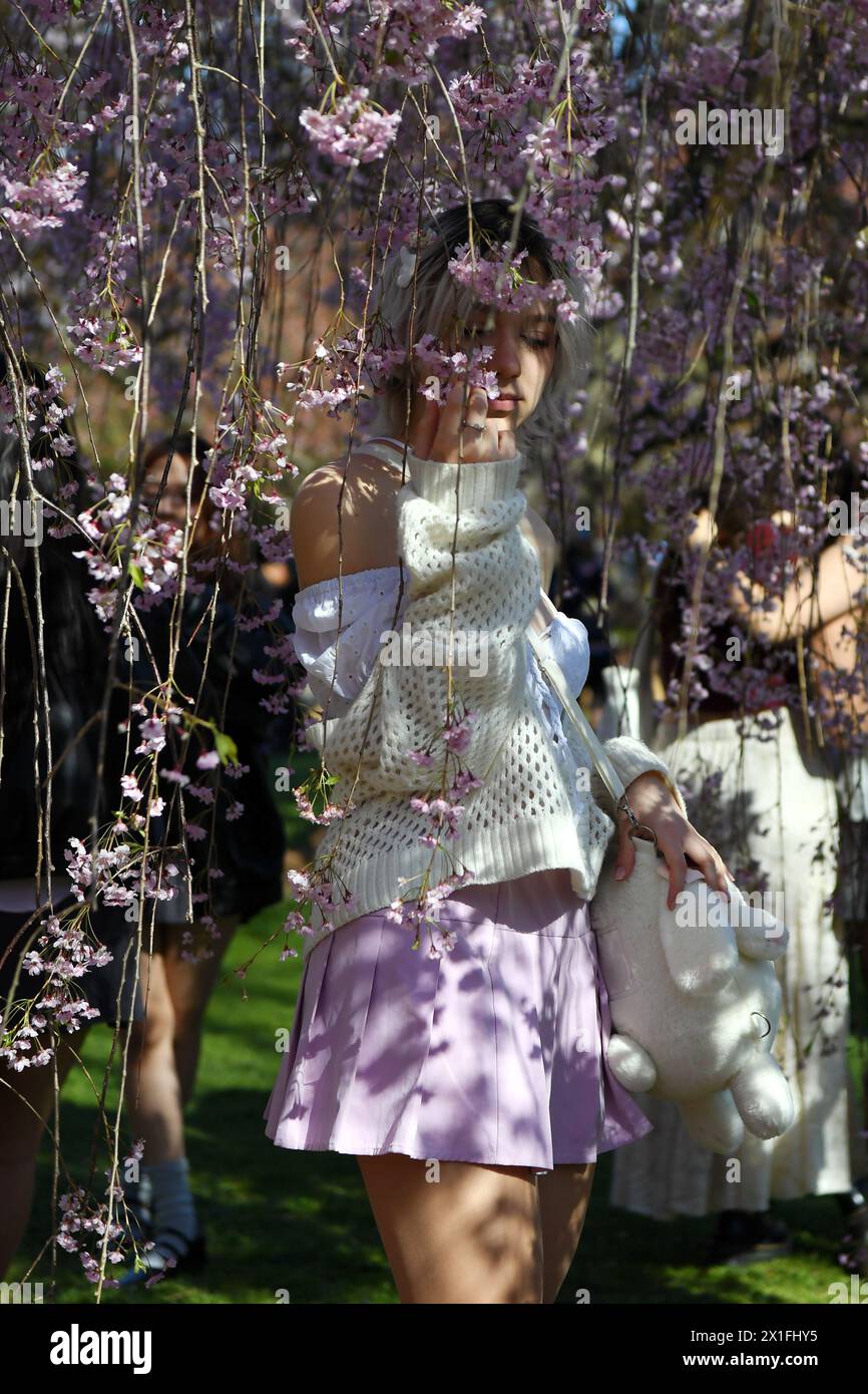 New York, USA. 14th Apr, 2024. A young woman poses for photos under ...