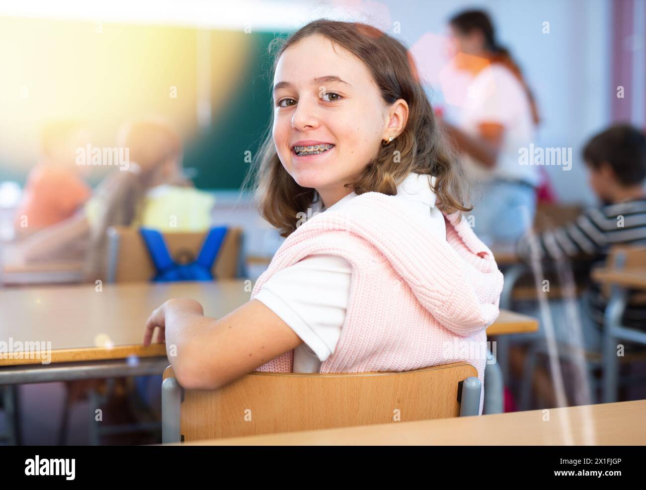 Portrait of girl sitting at desk in classroom Stock Photo - Alamy