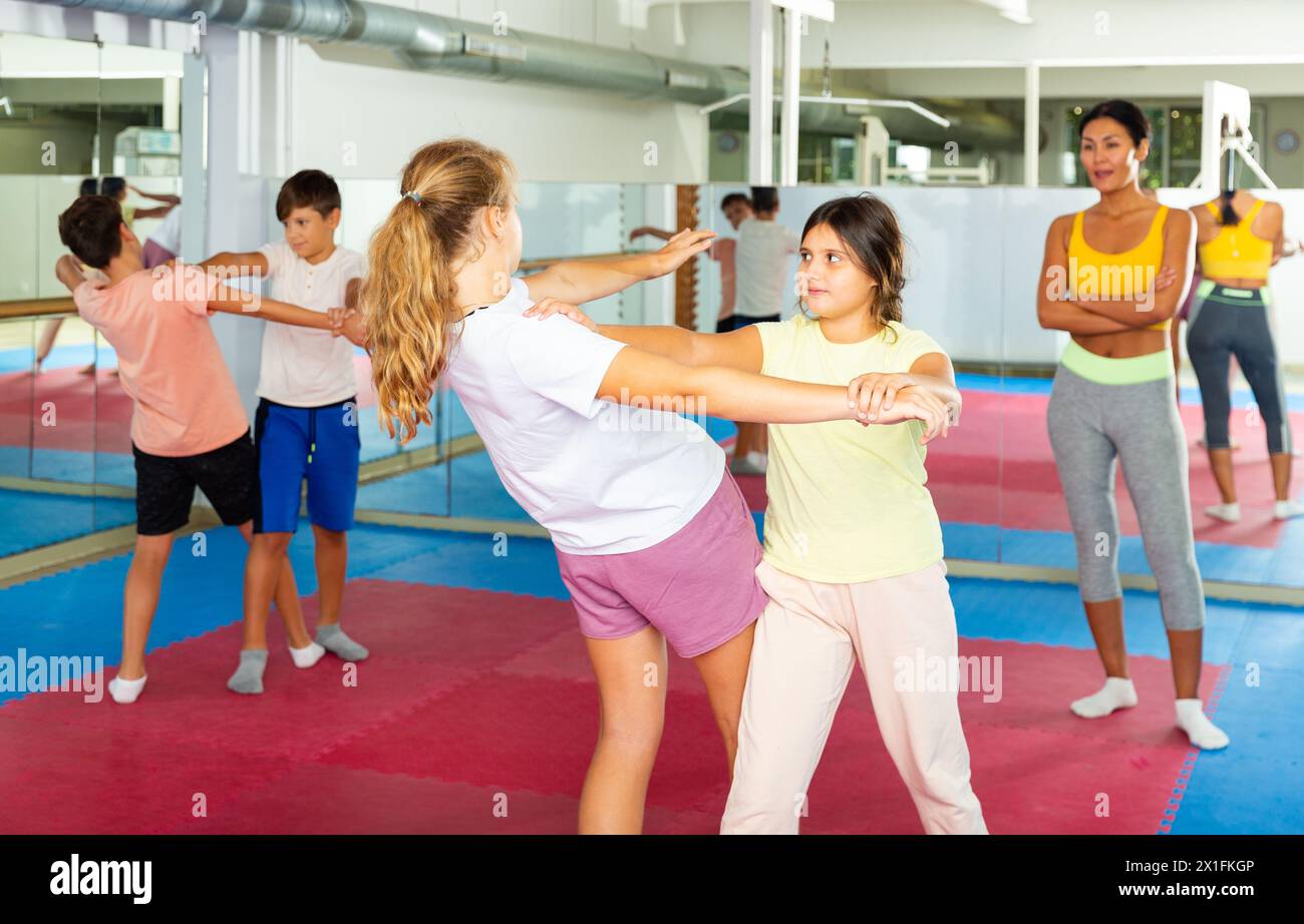 Group of kids training self-defence moves in gym Stock Photo - Alamy