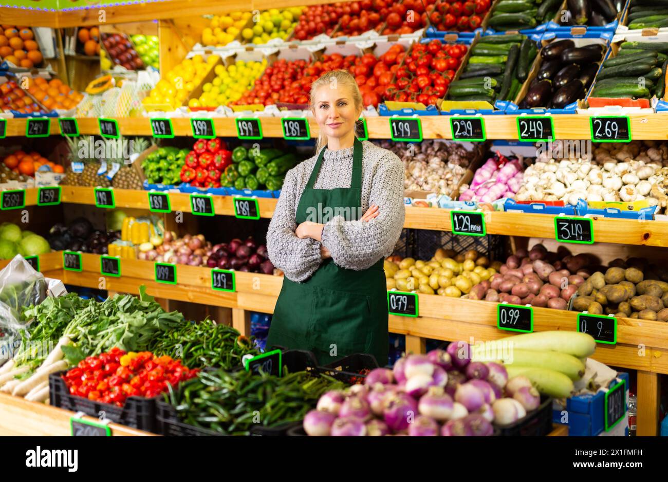 Successful female grocery store owner standing near fruits and ...