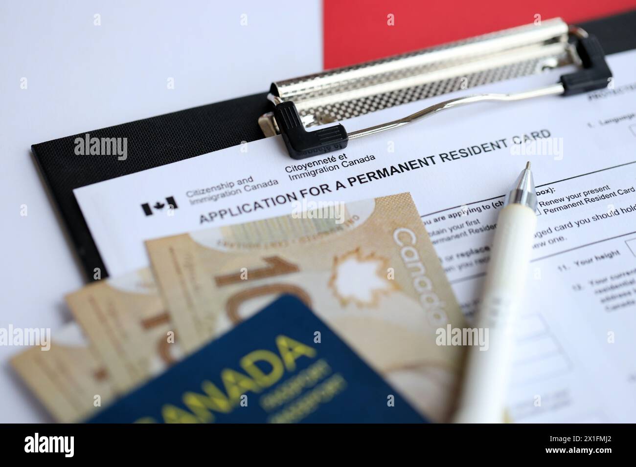 Application for permanent resident card on table with pen and canadian ...