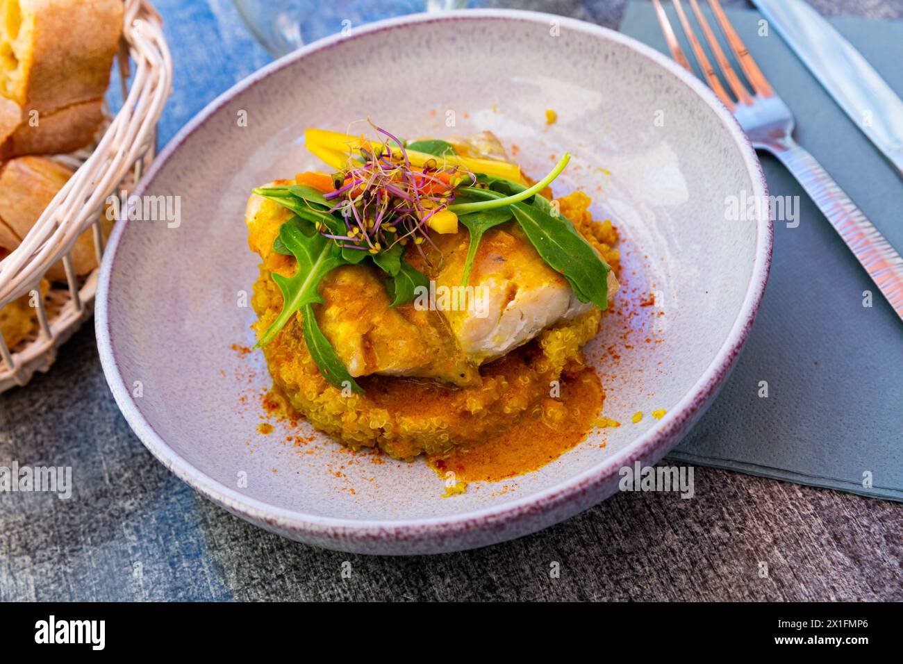 Fried pollock fillet with quinoa, curry and vegetables Stock Photo - Alamy