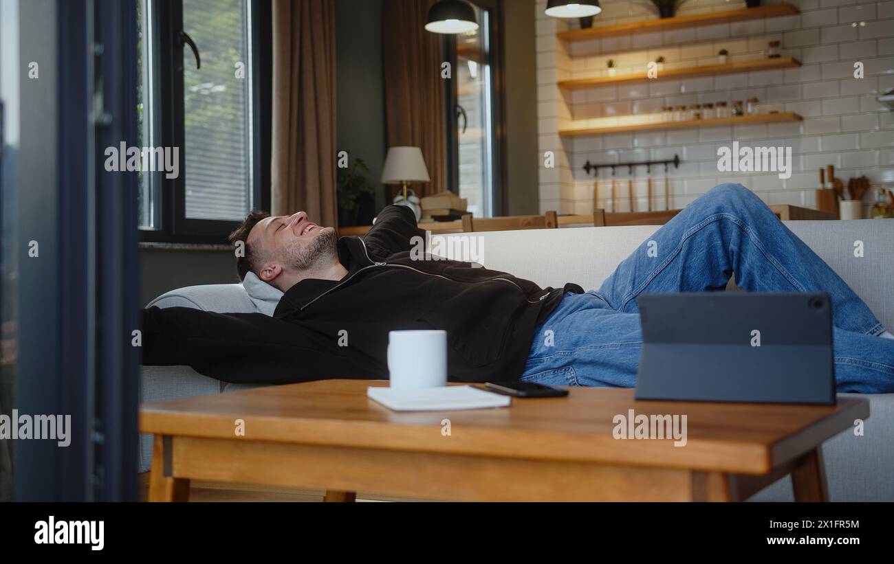 Tired man falls on cozy hi-res stock photography and images - Alamy