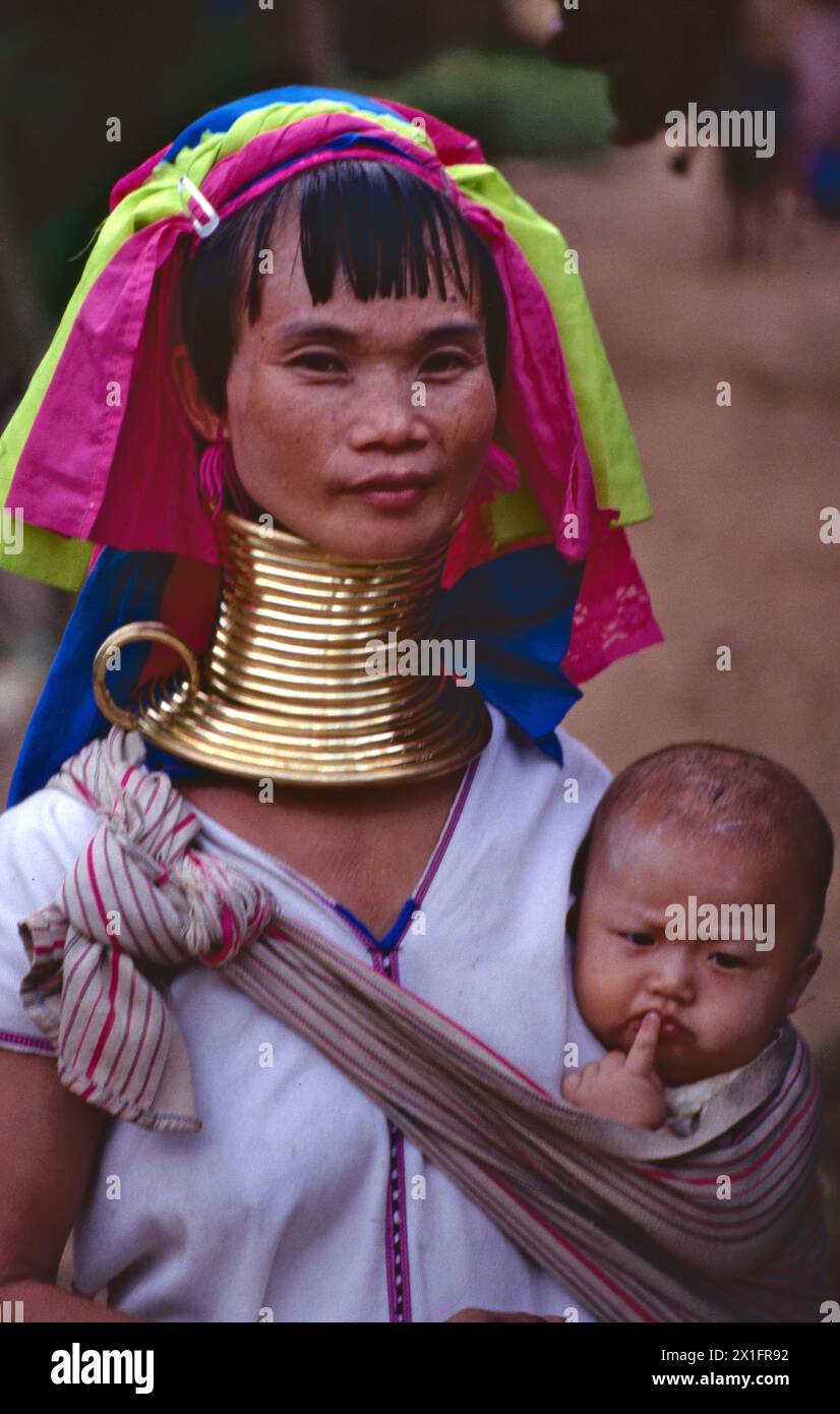 An indigenous Padaung (long neck Karen) woman with her baby in northern ...