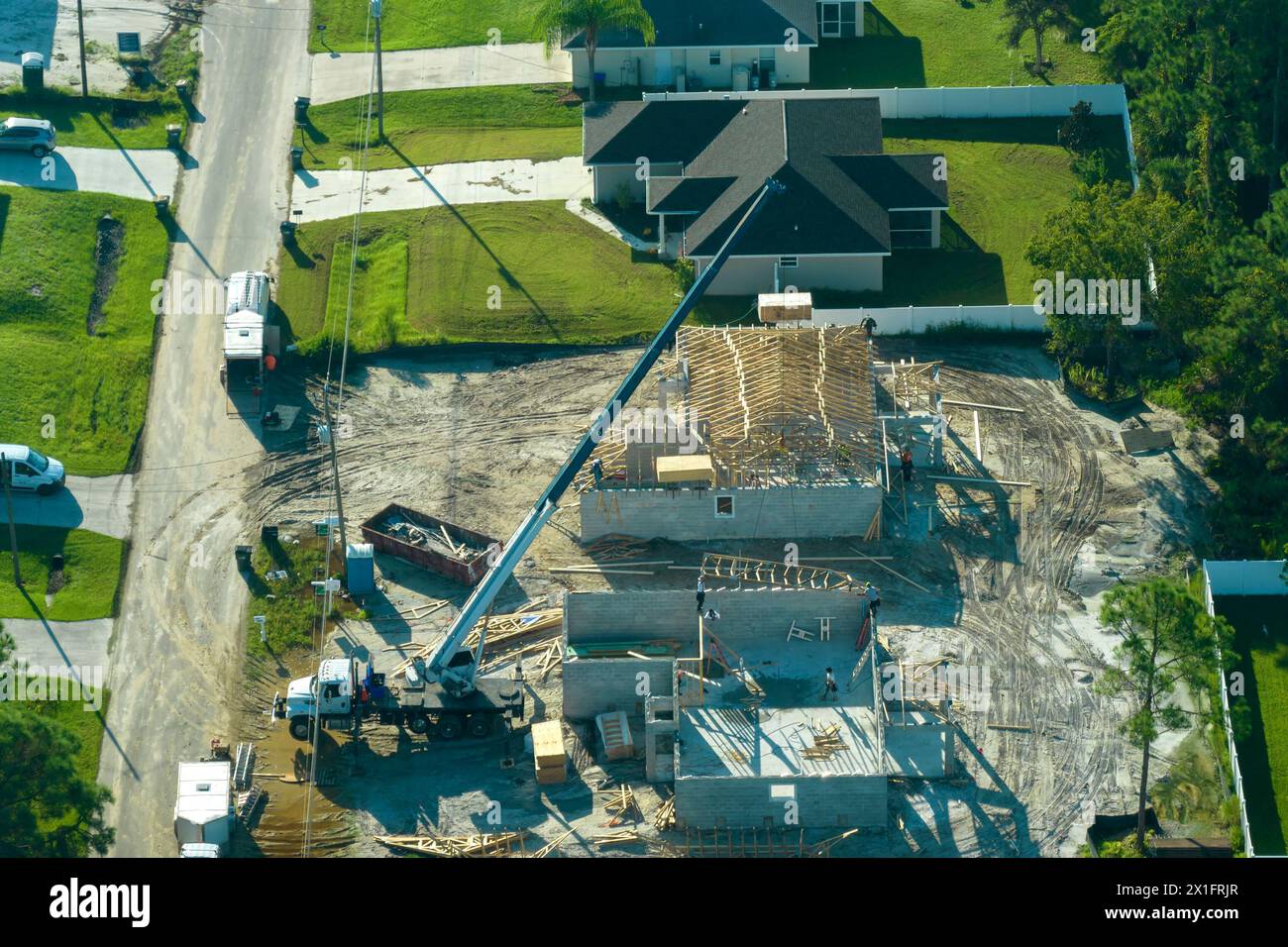 Aerial view of lifting crane and builders working on unfinished ...