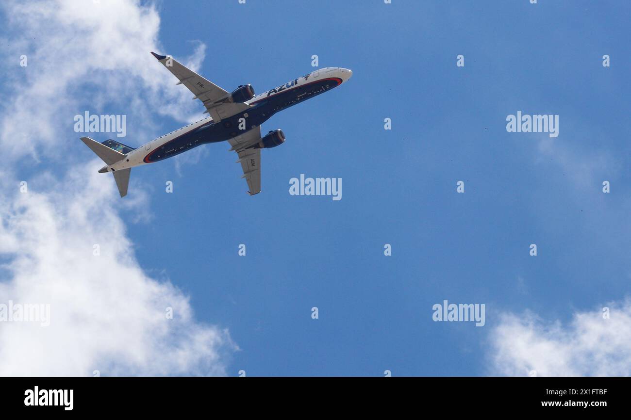 Airplane shortly after takeoff, blue sky background Stock Photo - Alamy