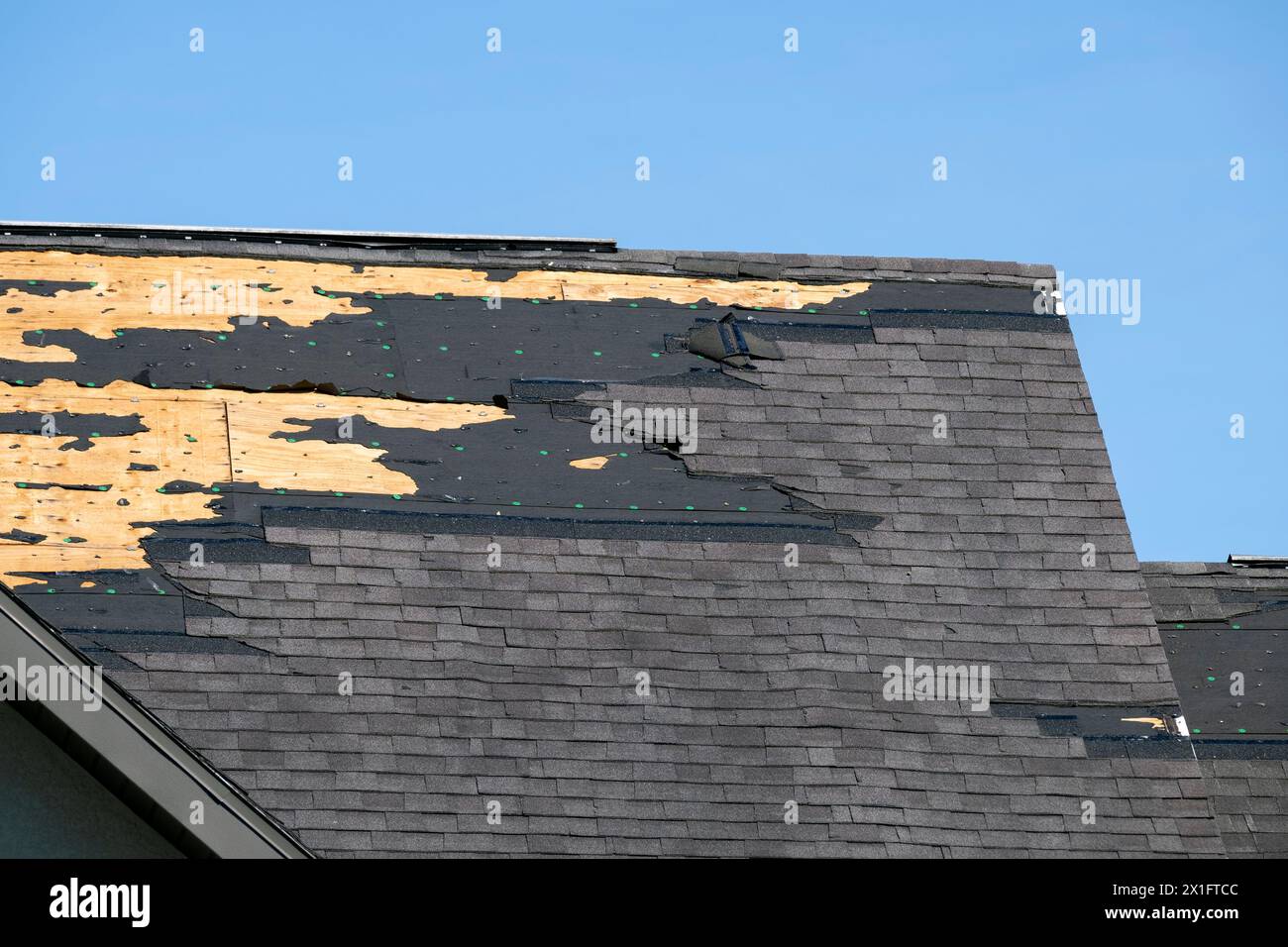 Consequences of natural disaster. Damaged house roof with missing ...