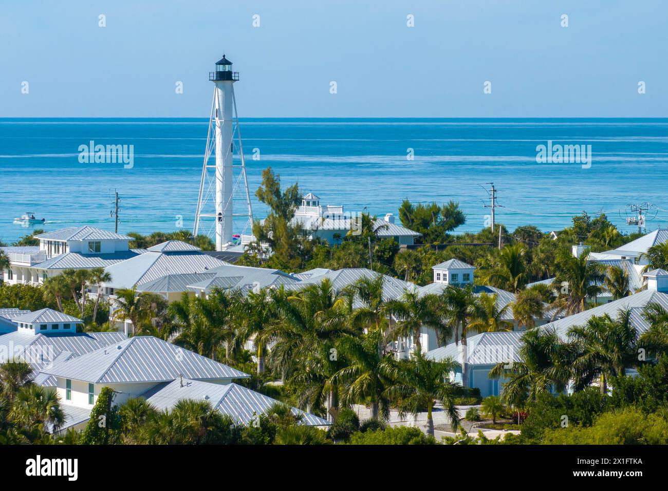 Expensive waterfront houses and white Boca Grande lighthouse on ocean ...
