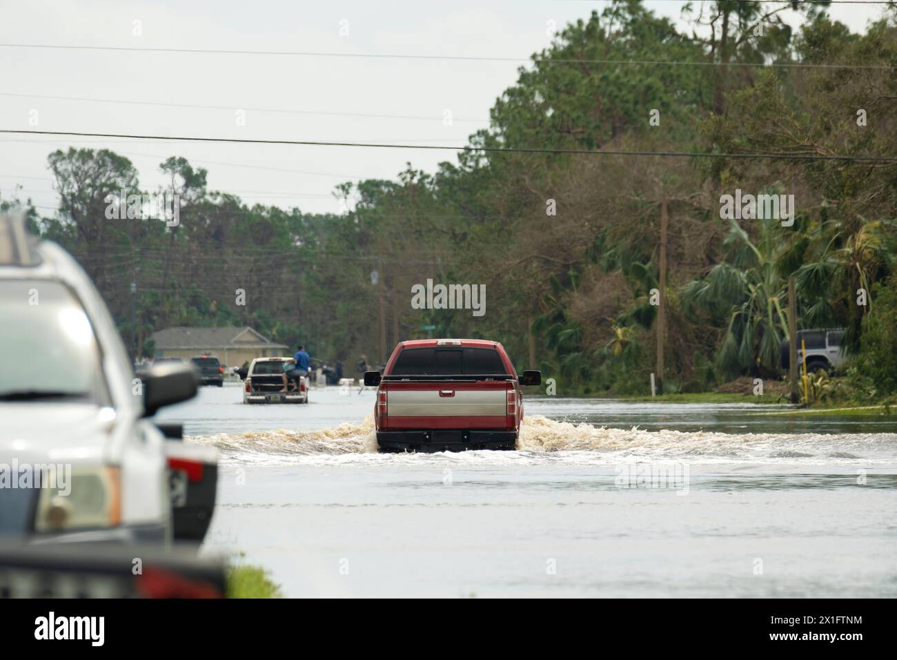 Flooded road in Florida after heavy hurricane rainfall. Evacuating cars ...