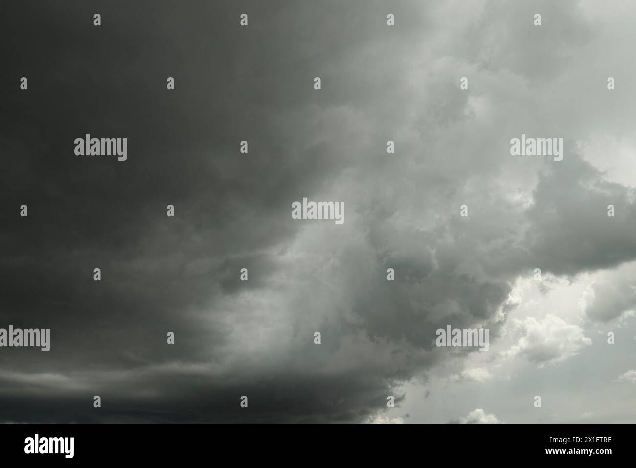 Heavy rain falling down from stormy clouds during thunderstorm on dark sky. Moving and changing ...