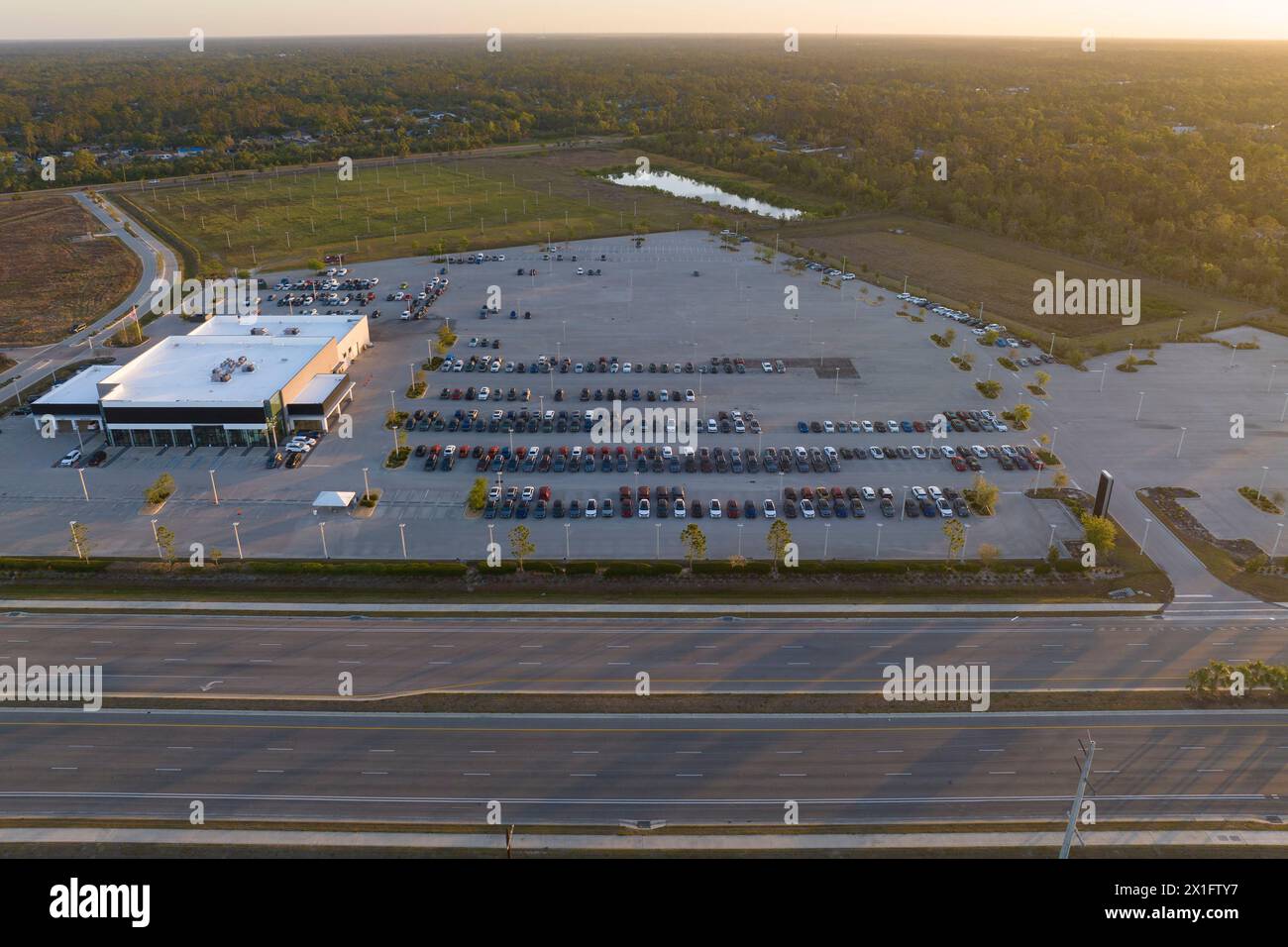 Large parking lot of local dealer with many brand new cars parked for ...