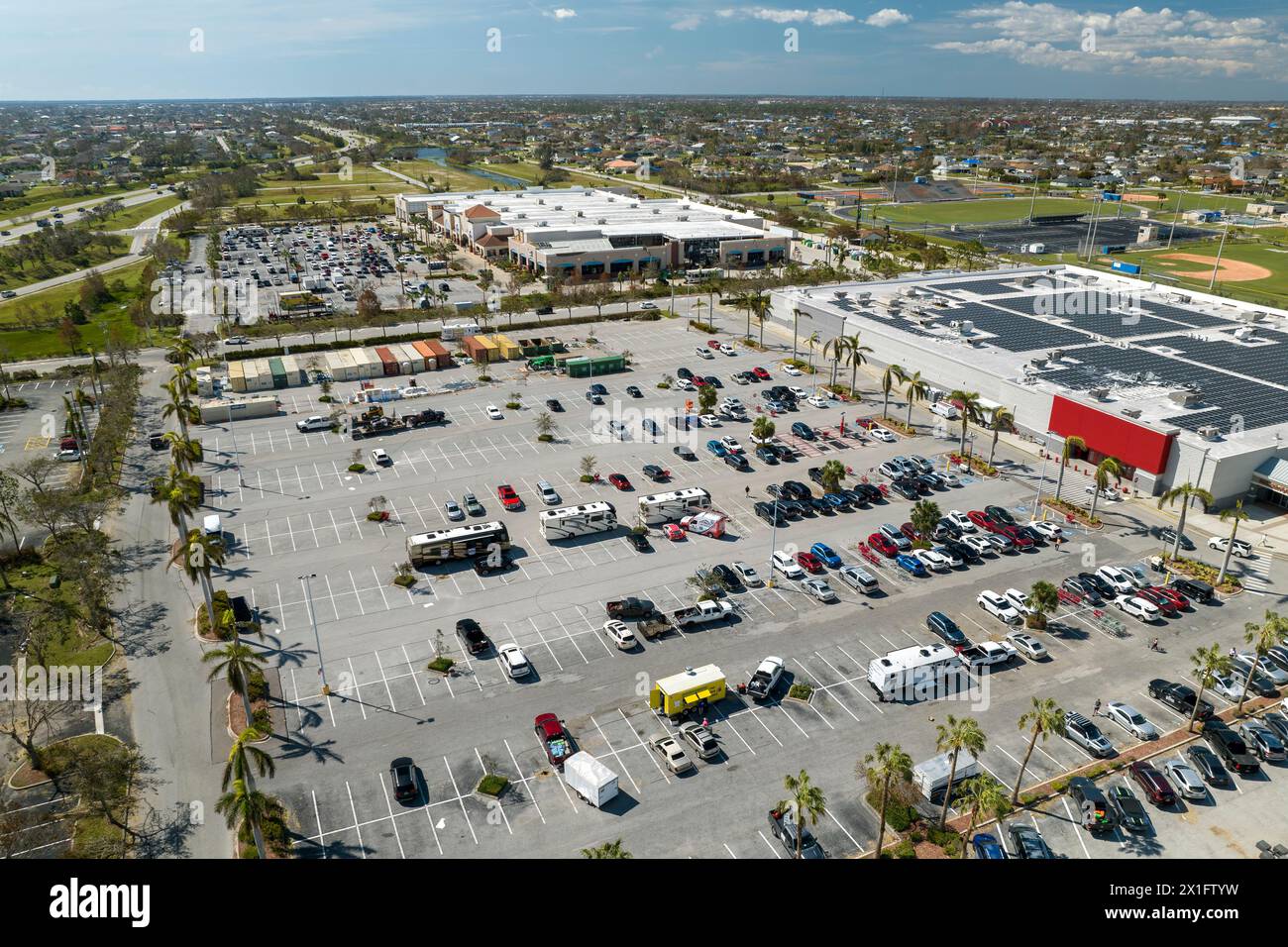 Many parked cars on store parking lot with lines and markings for ...