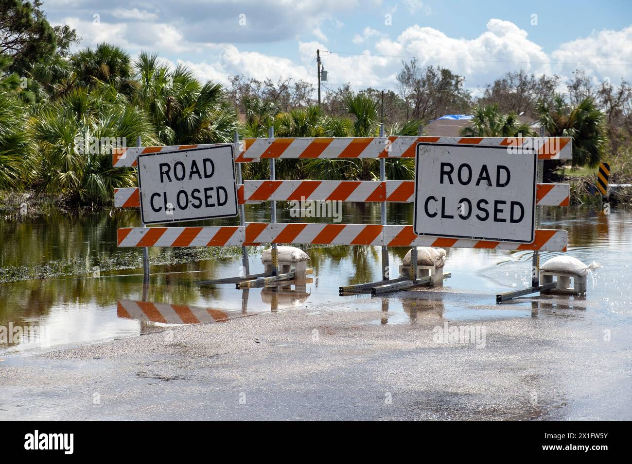 Road closed for roadworks and danger of flooding with warning signs ...