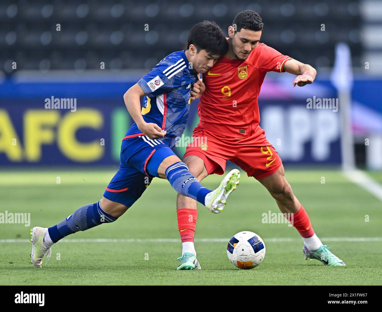 Doha, Qatar. 16th Apr, 2024. Behram Abduweli (R) of China vies with ...