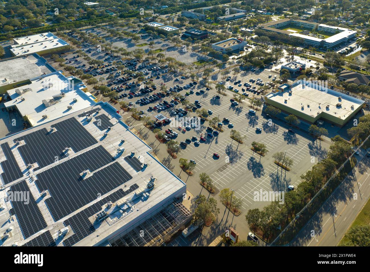 Top view of many cars parked on a parking lot in front of a shopping ...