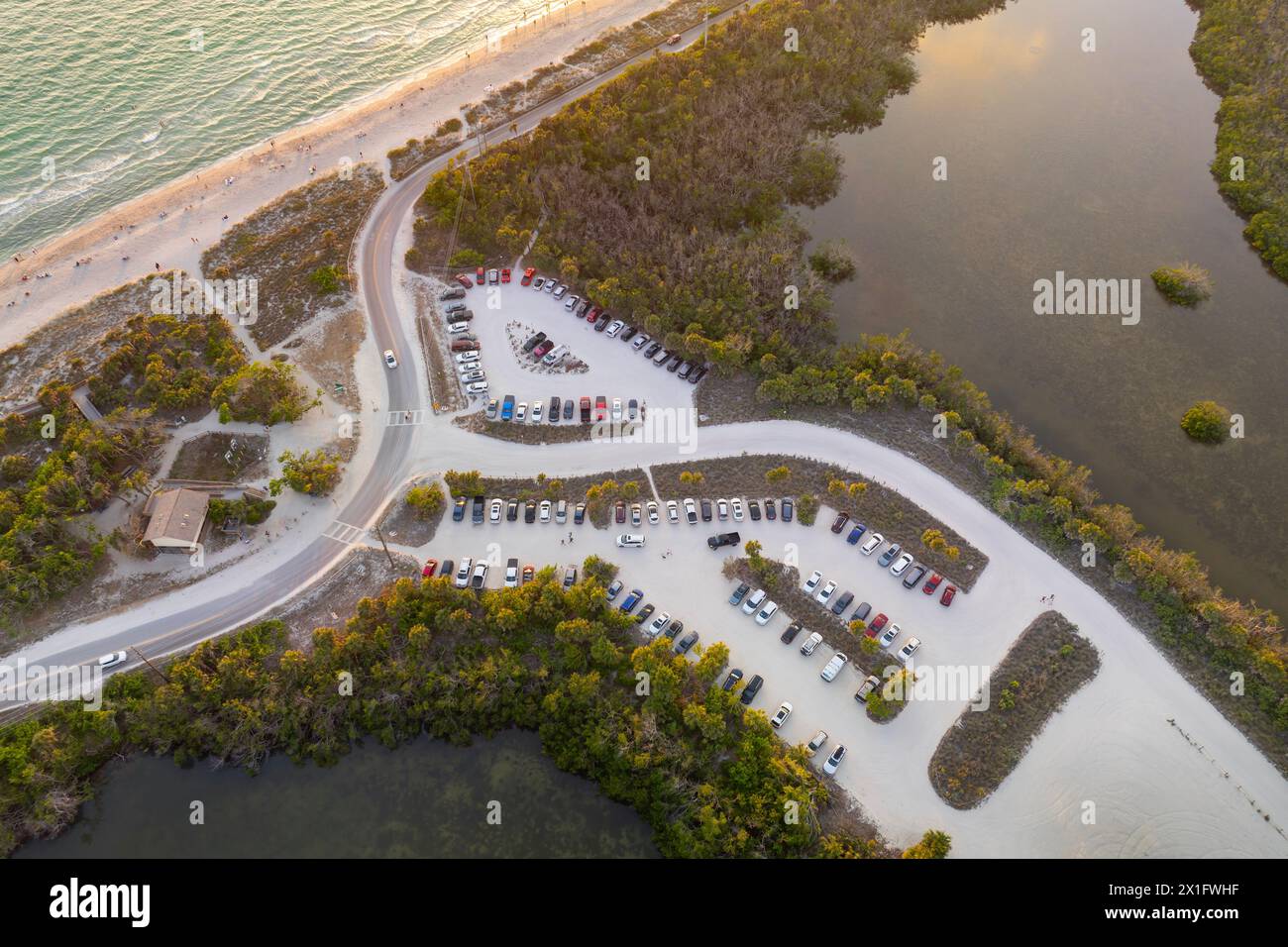 Vehicle parking area with cars parked on ocean beach parking lot at ...