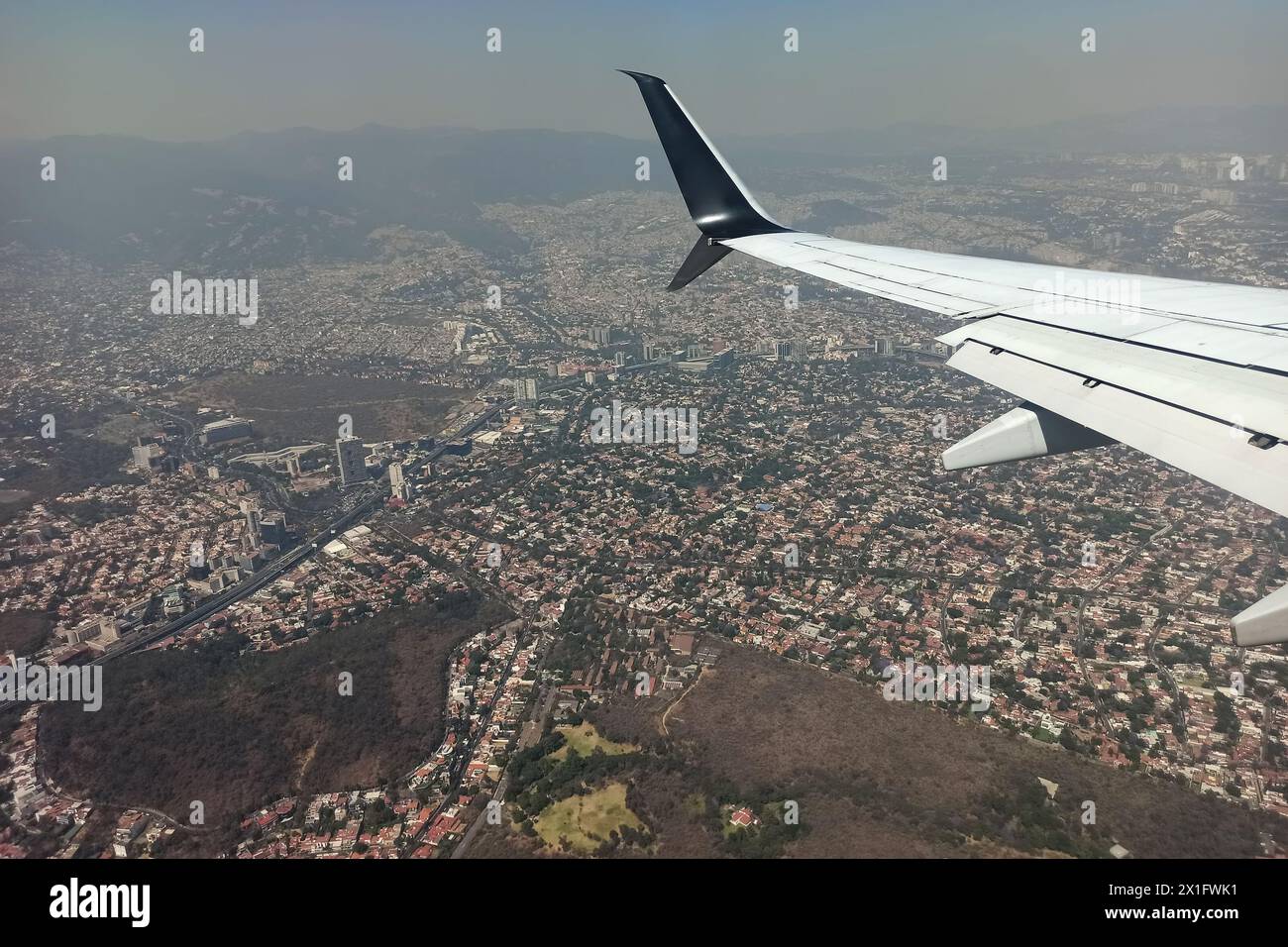 View through airplane window of commercial jet plane wing flying high ...